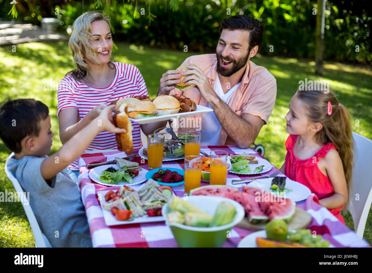 Cheerful family enjoying meal in yard Stock Photo - Alamy