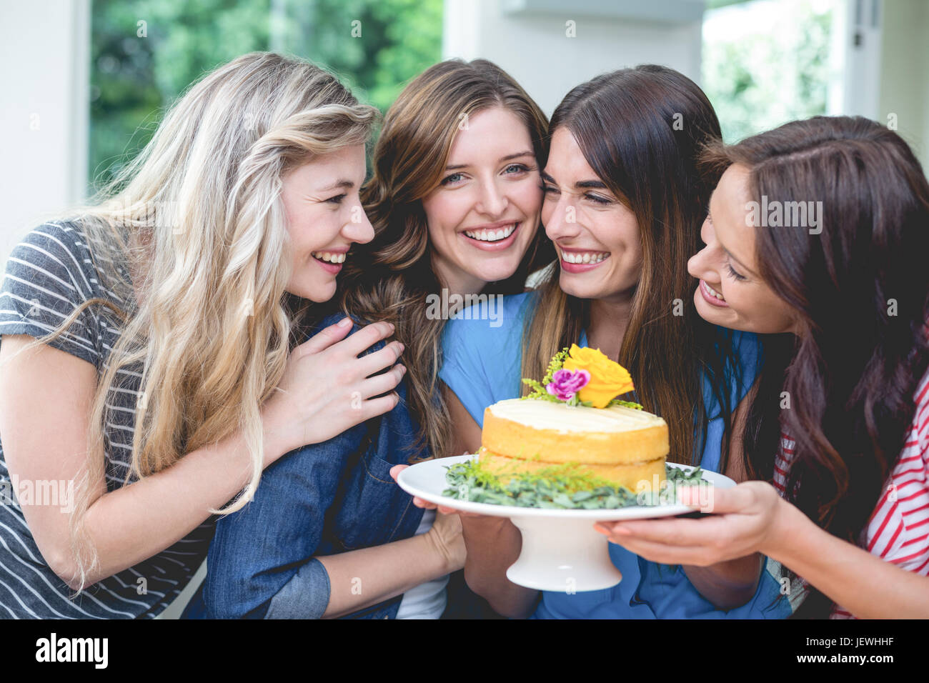 Beautiful women holding a birthday cake Stock Photo - Alamy