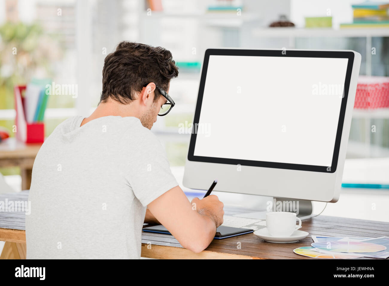 Young man using pen tablet and computer Stock Photo - Alamy