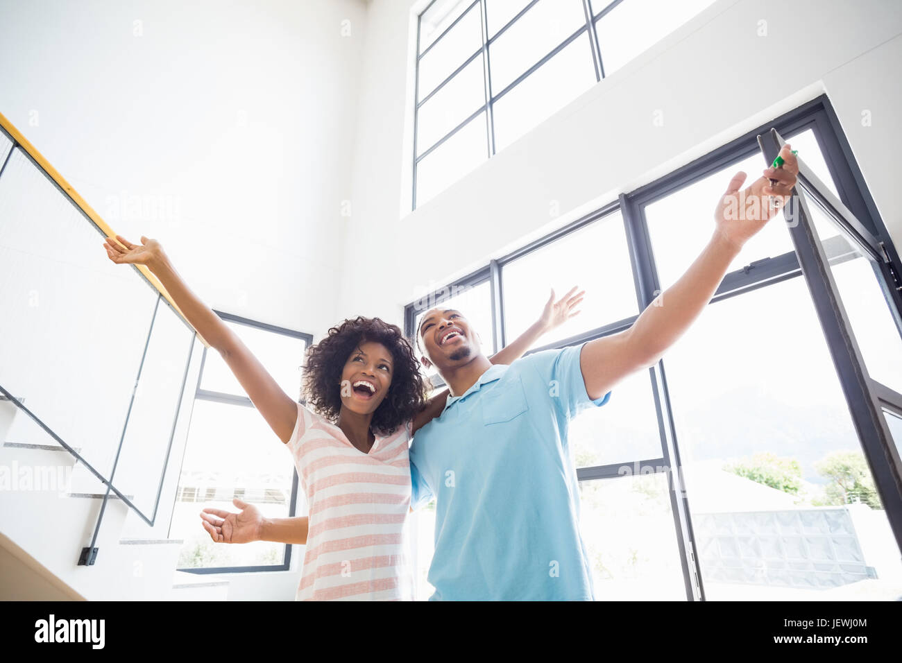 Excited young couple in their new home Stock Photo - Alamy