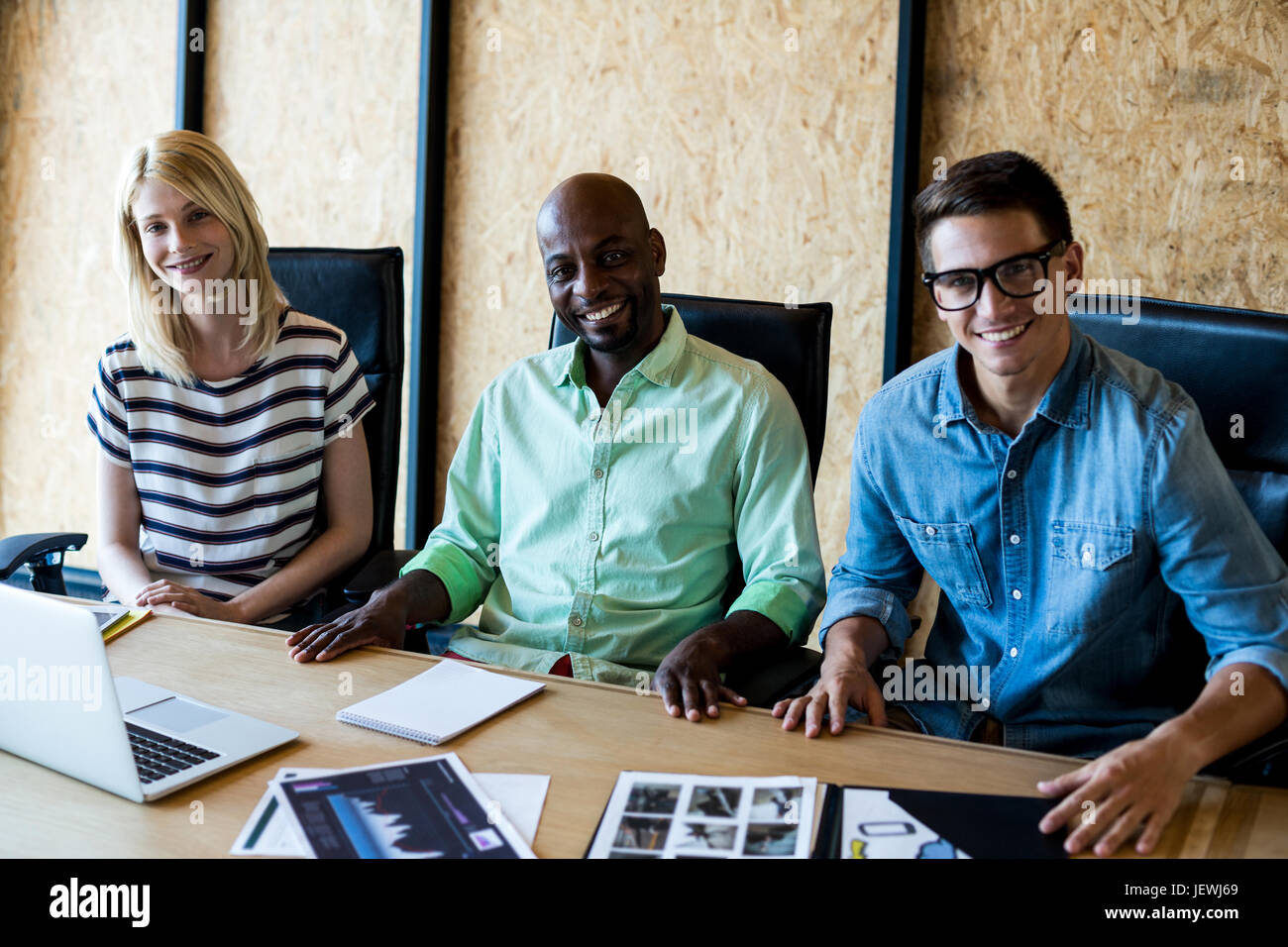 Colleagues sitting at their desk Stock Photo - Alamy