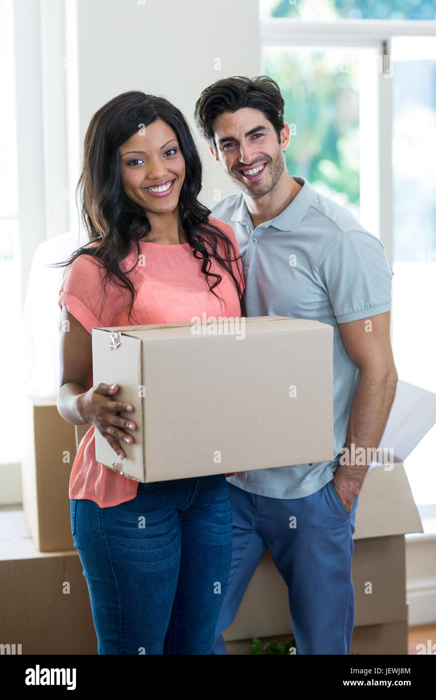 Young couple carrying cardboard box Stock Photo - Alamy