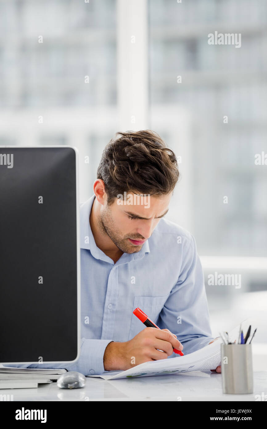 Businessman taking notes at his desk Stock Photo - Alamy