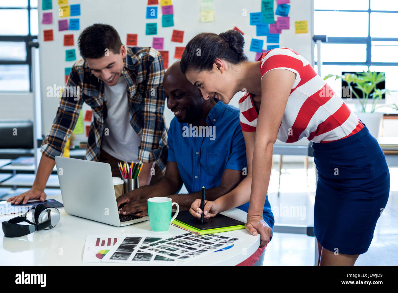 Graphic designers working at their desk Stock Photo - Alamy
