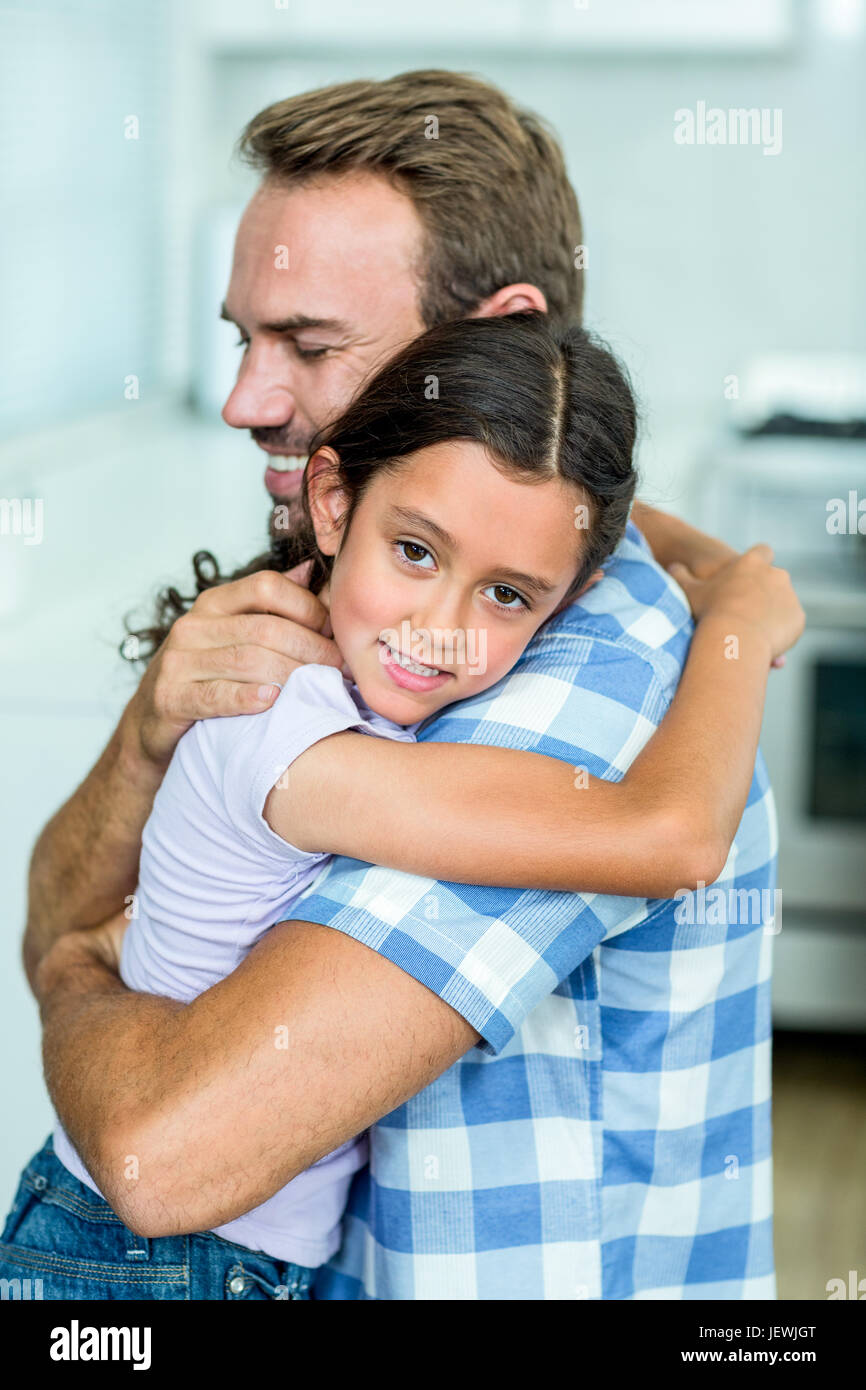 Happy father hugging daughter at home Stock Photo - Alamy