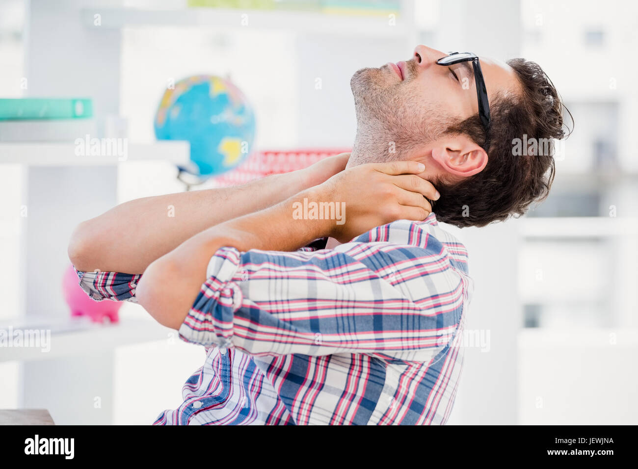 Stressed young man sitting at his desk Stock Photo - Alamy
