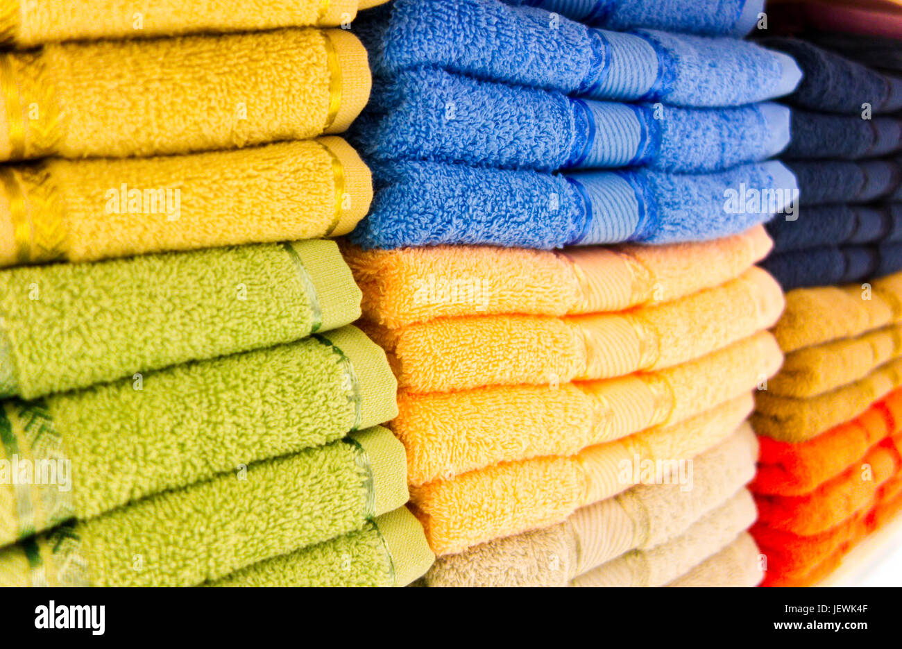 Stacks of different colors towels Stock Photo - Alamy