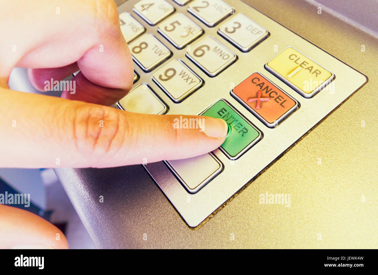 Woman finger press Enter on ATM. Close-up Stock Photo - Alamy