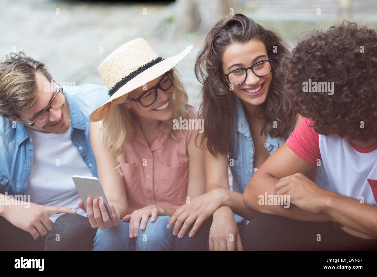Friends interacting with each other Stock Photo - Alamy