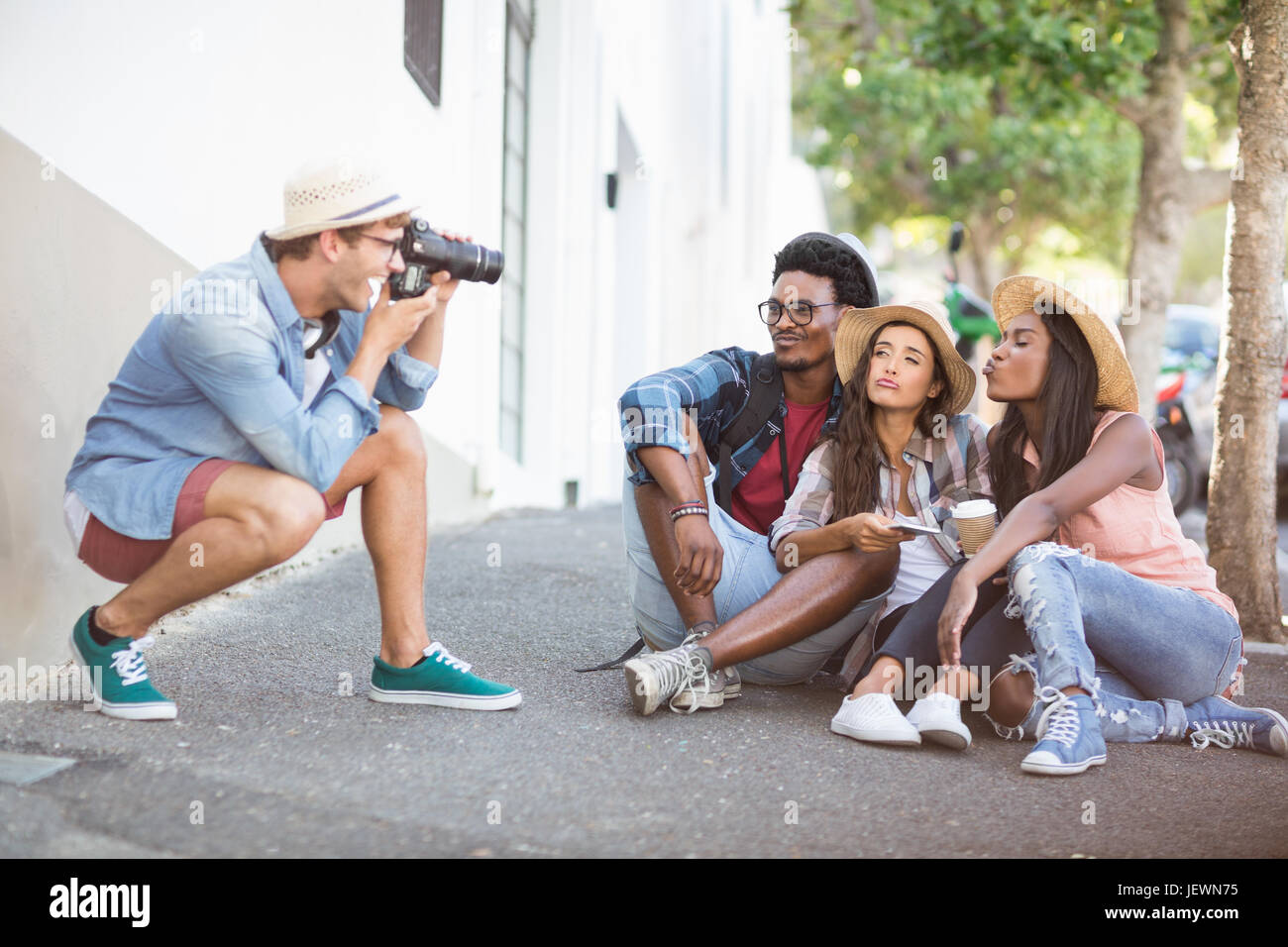 Man taking photo of his friends Stock Photo - Alamy