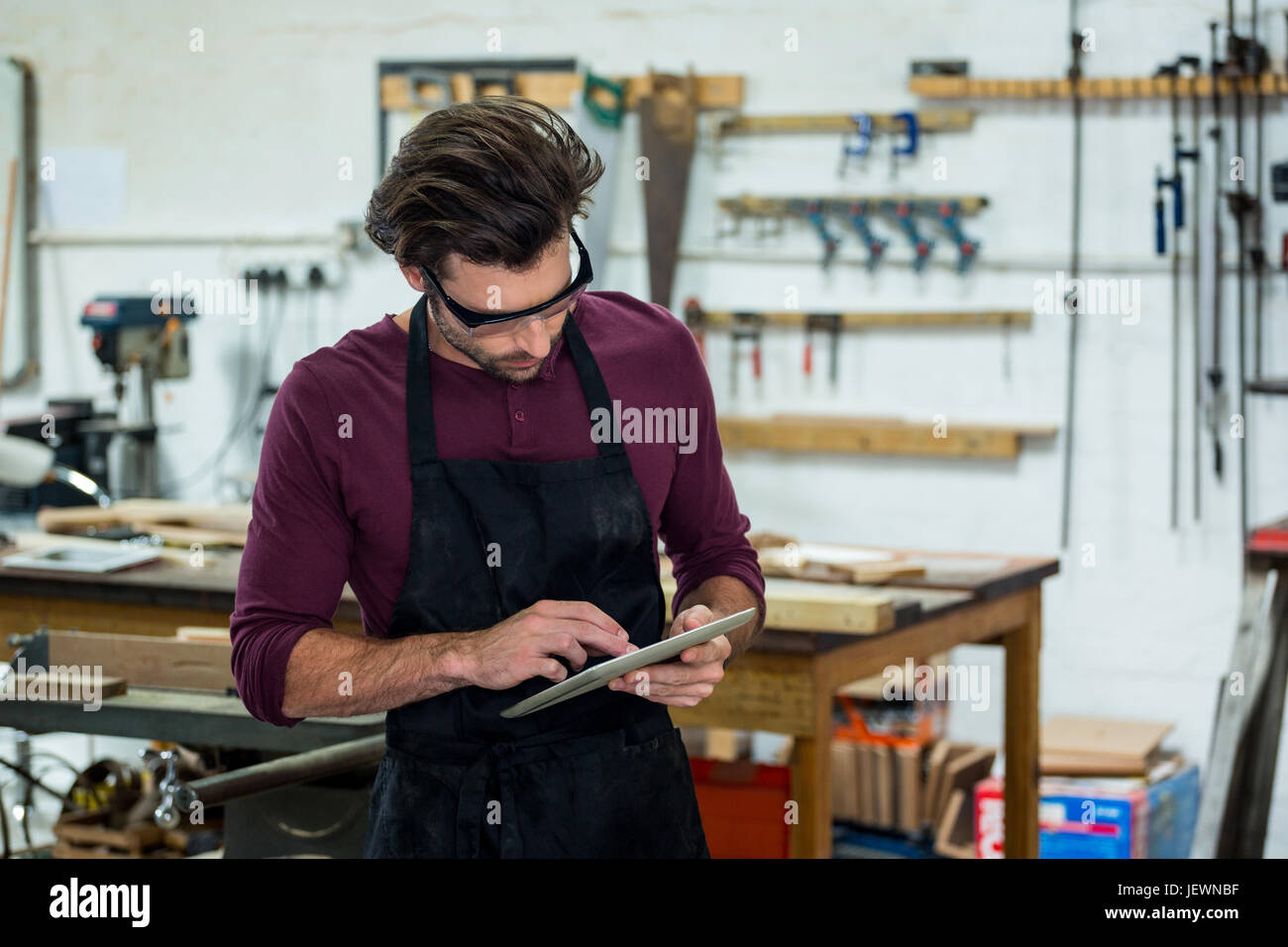 Carpenter is using his tablet Stock Photo - Alamy