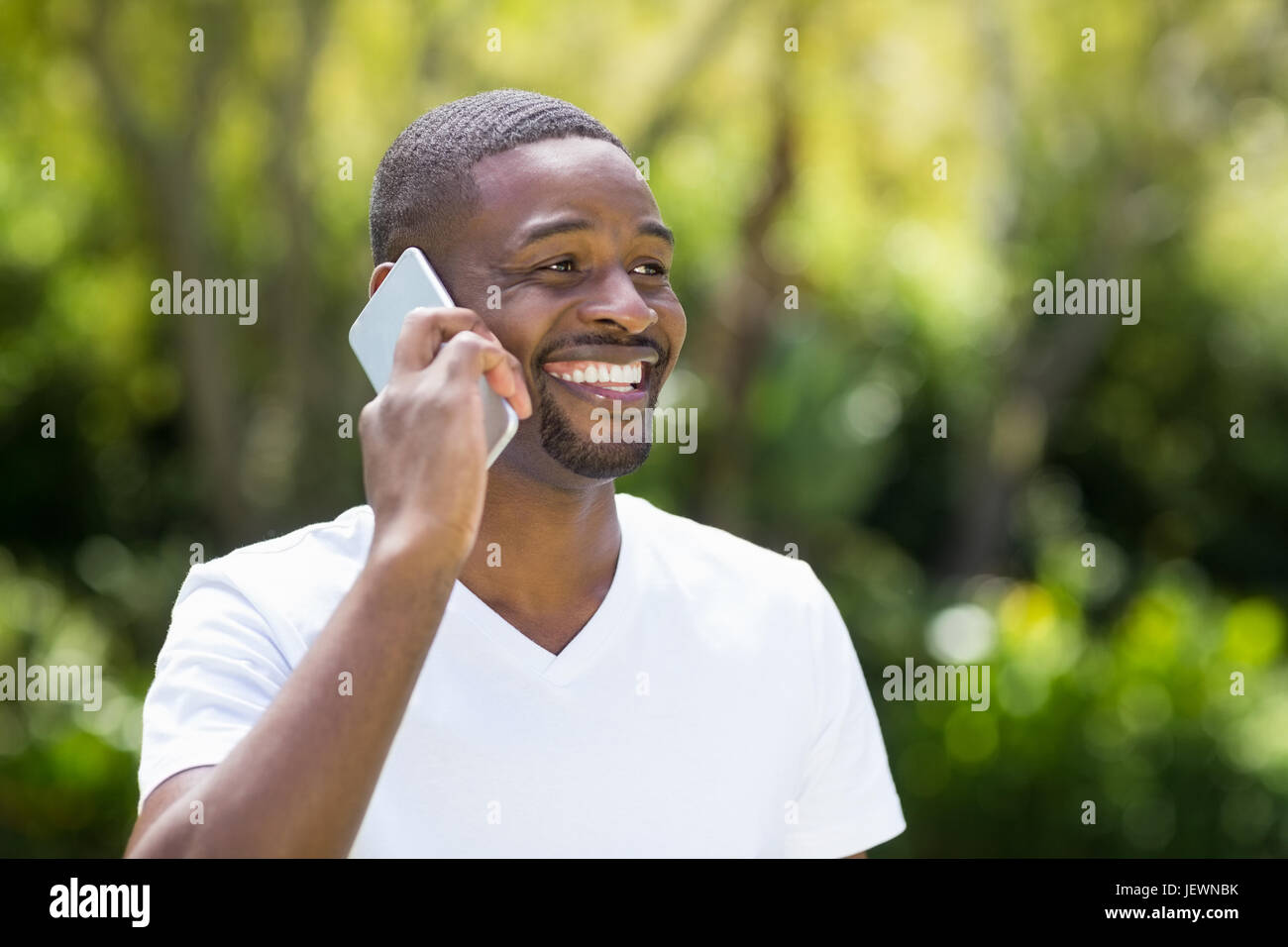 Happy man talking on the phone Stock Photo - Alamy