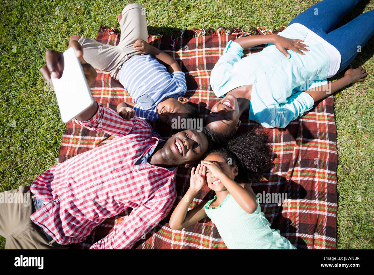 Happy family relaxing together Stock Photo - Alamy