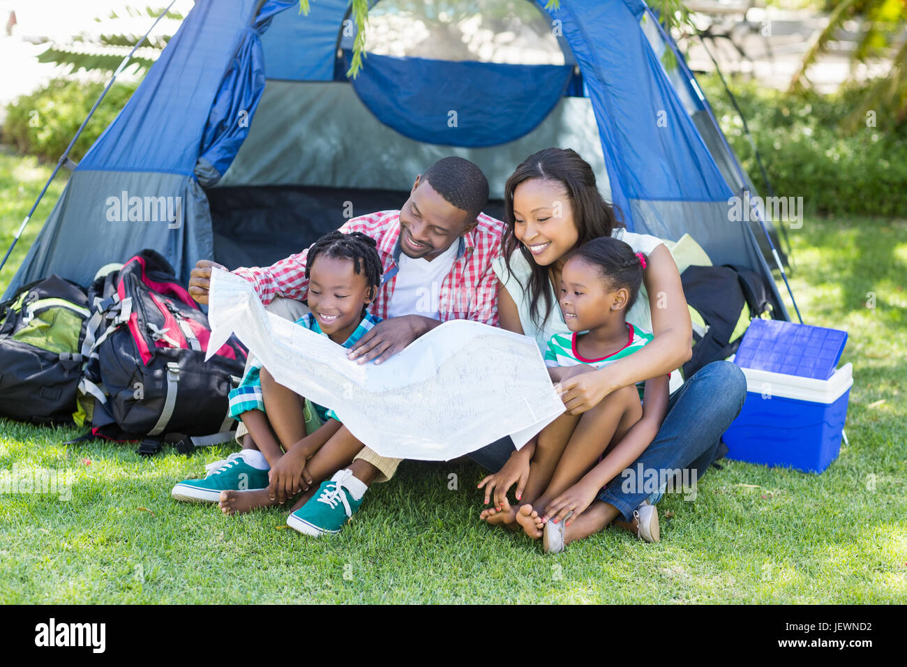 Happy family reading the map Stock Photo - Alamy