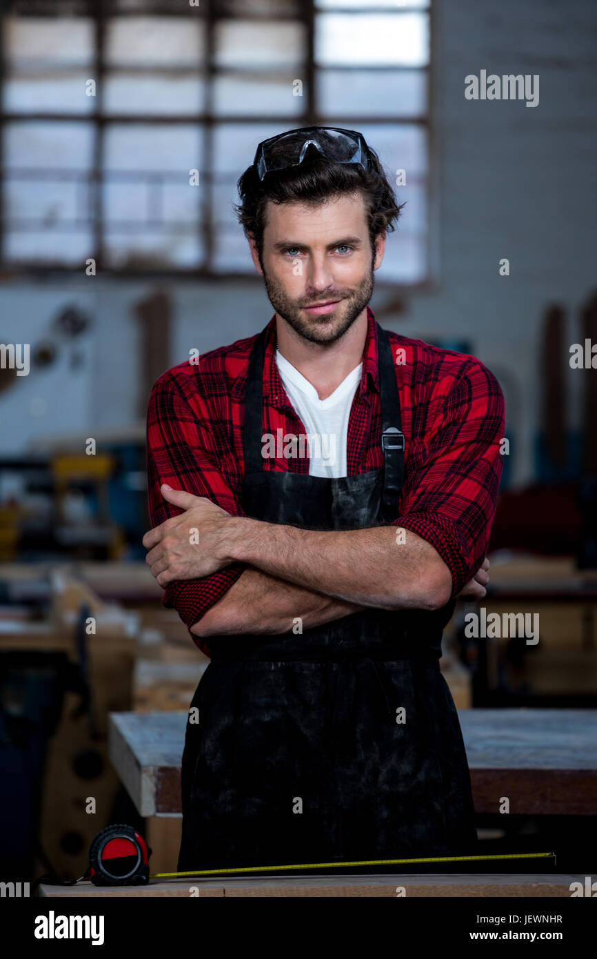 Carpenter smiling and crossing arms Stock Photo - Alamy