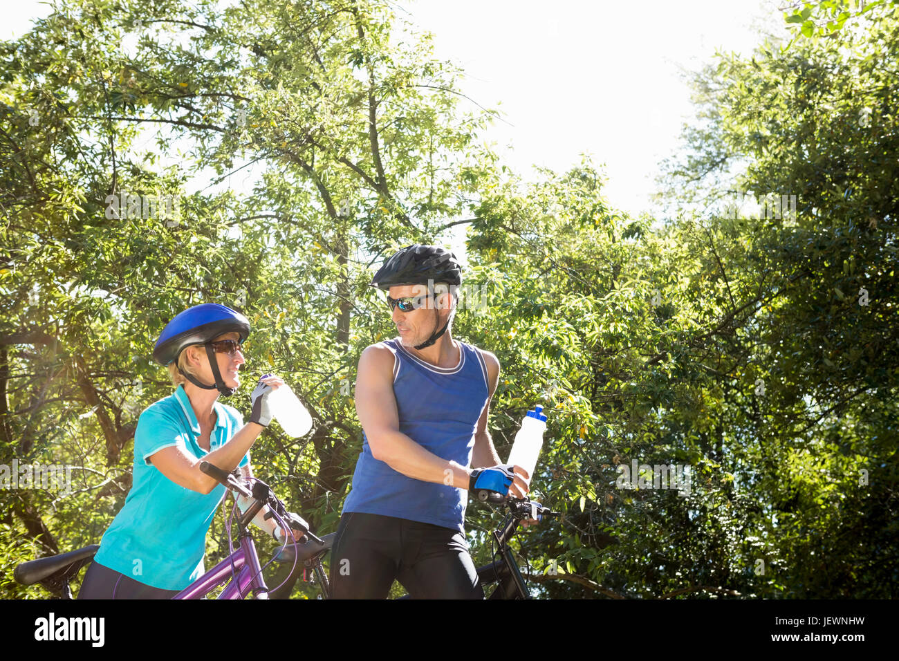 Senior couple standing with their bikes Stock Photo - Alamy