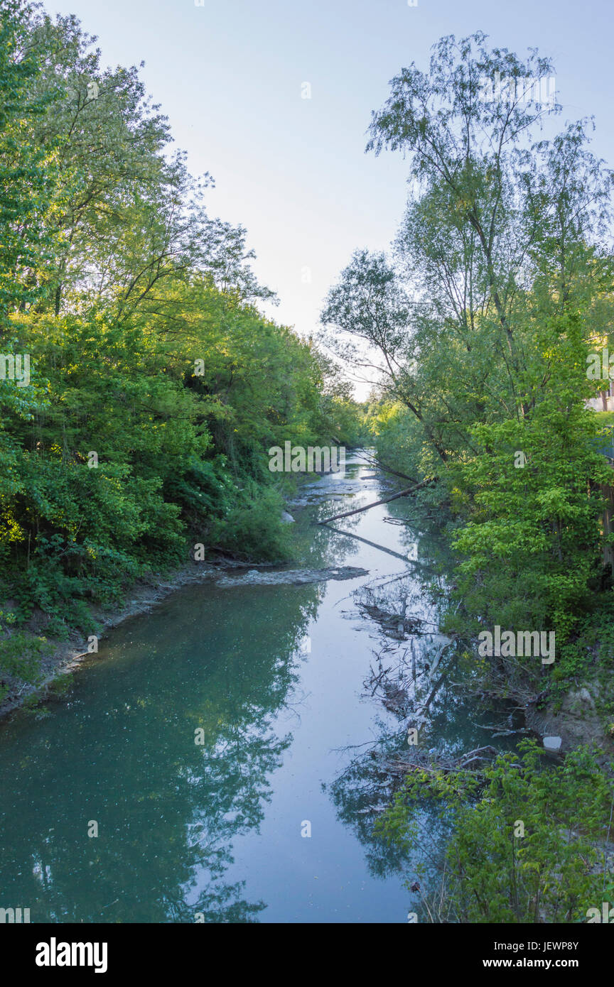 Italy, small river floating in a beautiful landscape on Appennino hills ...