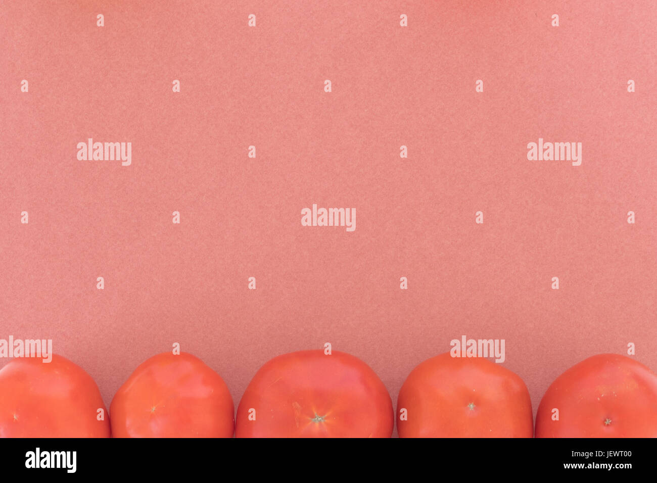A frame of tomatoes on a pink background. Abstract background. Template ...