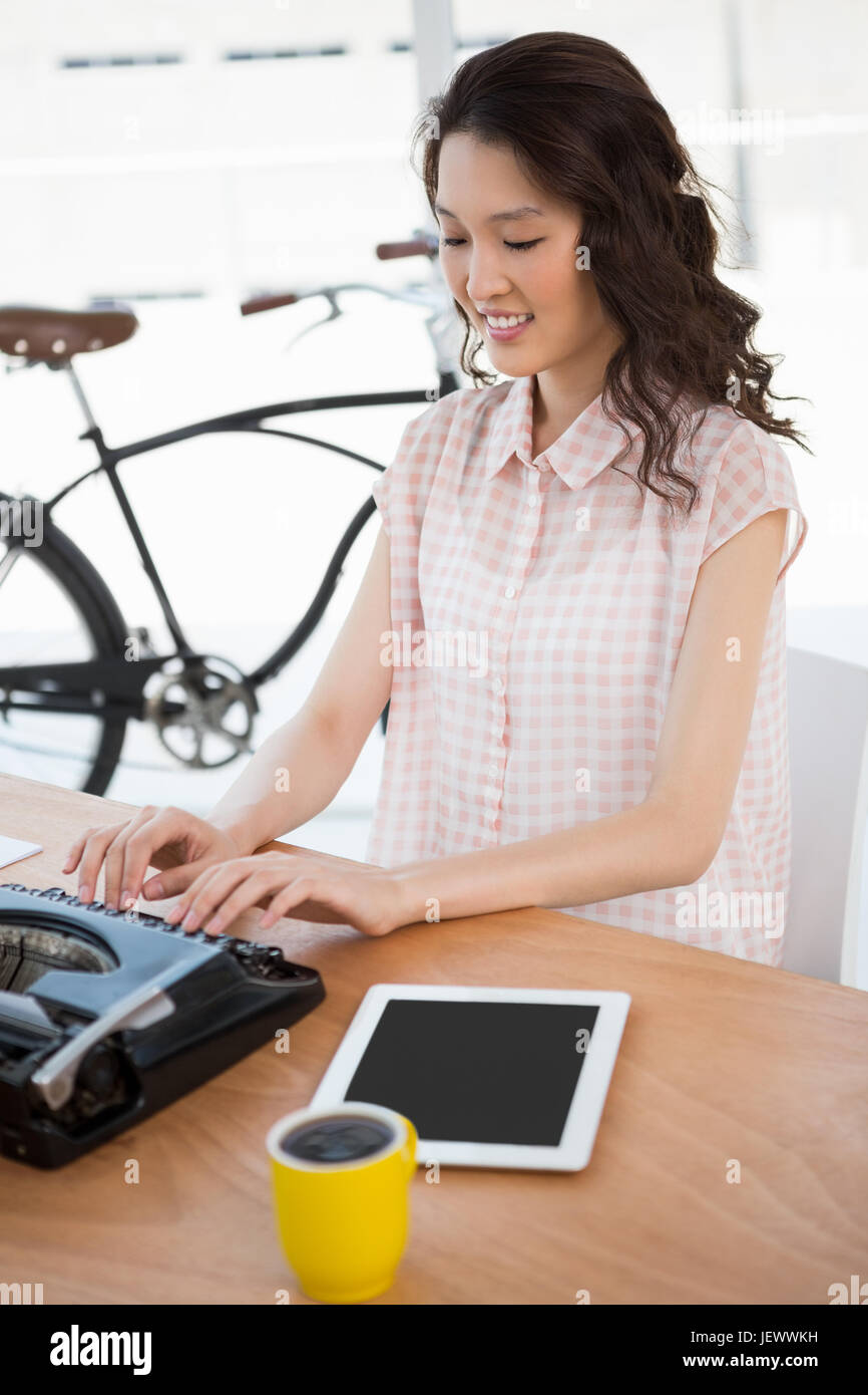 Hipster woman using a typewriter Stock Photo - Alamy