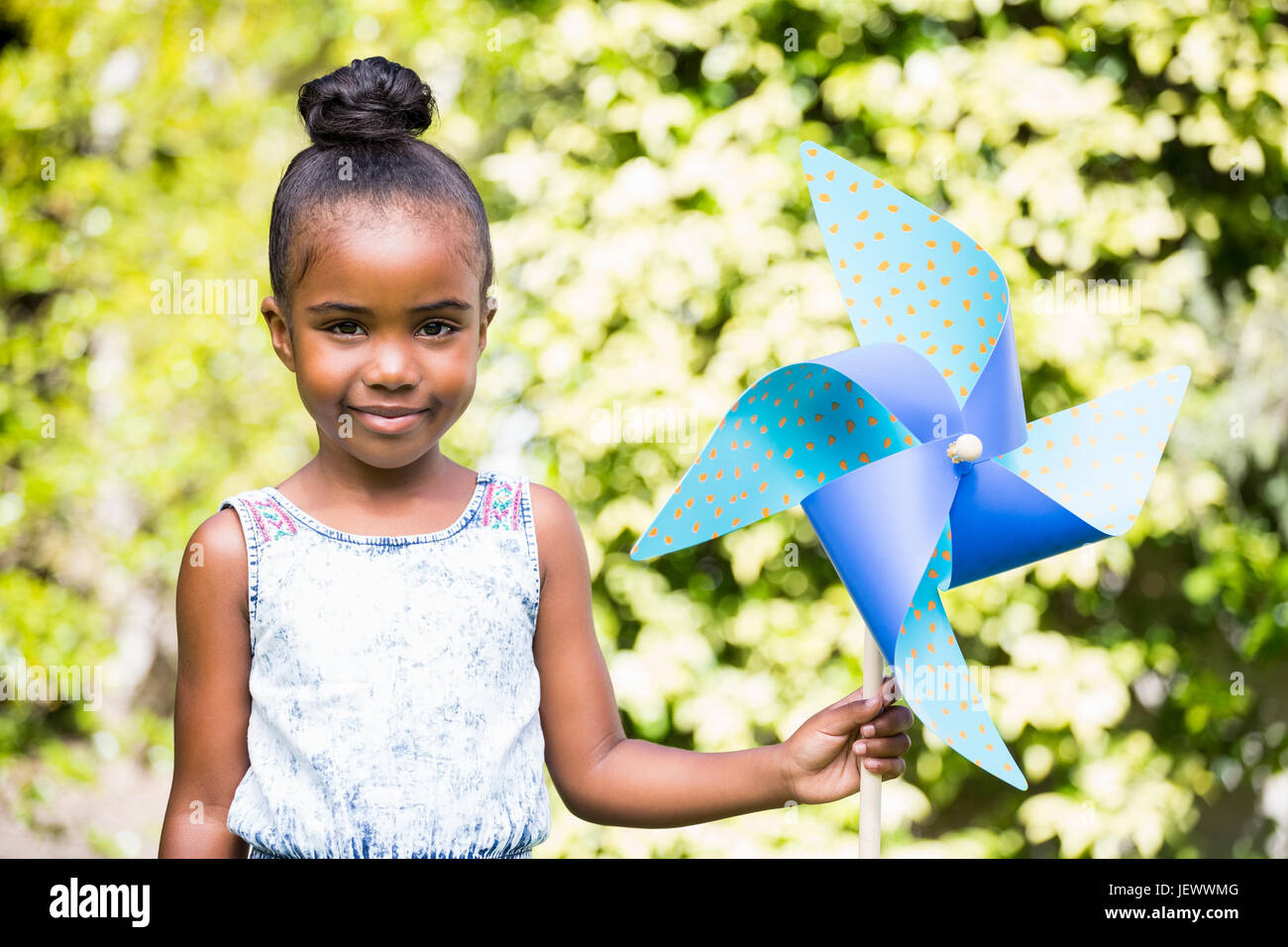 Girl with a pinwheel hi-res stock photography and images - Alamy