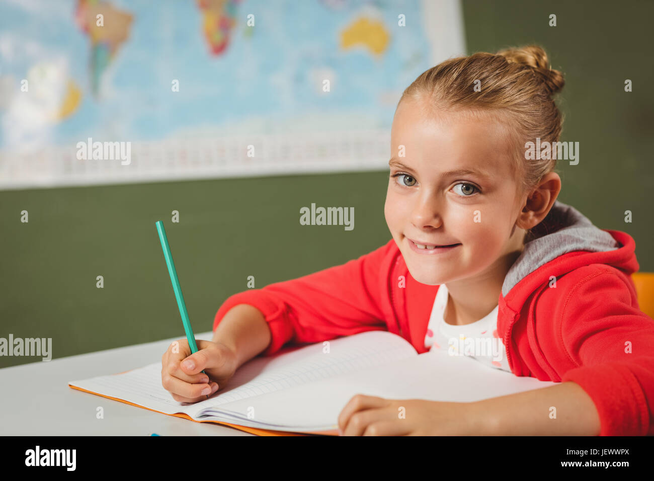 Girl writing in her notebook Stock Photo - Alamy