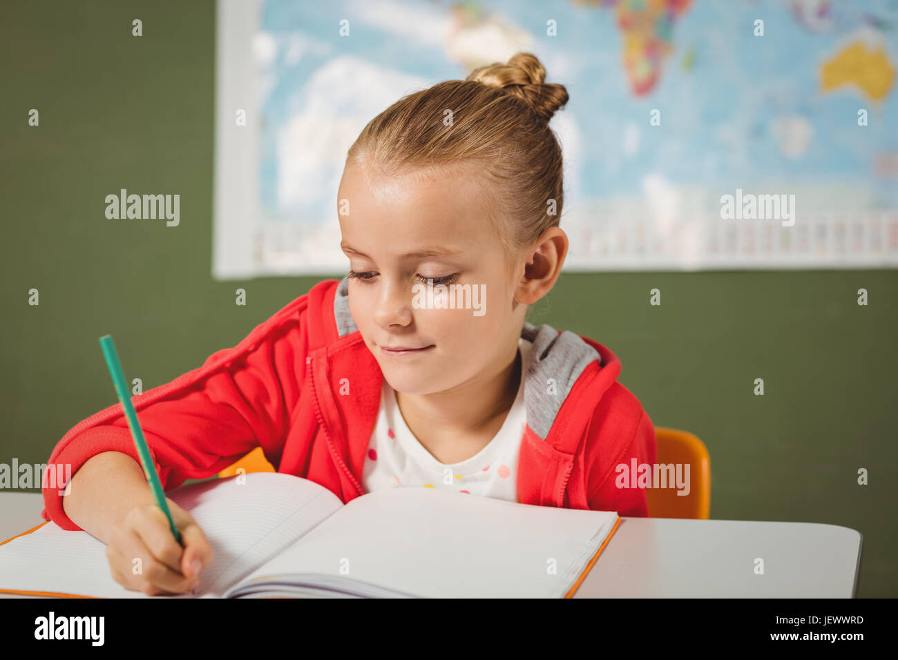 Girl writing in her notebook Stock Photo - Alamy