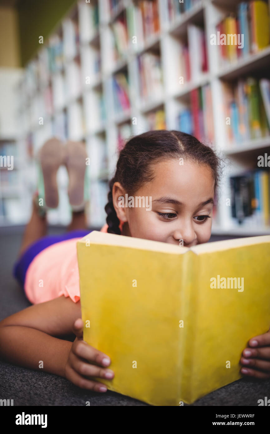 Close up of girl lying and reading a book Stock Photo - Alamy