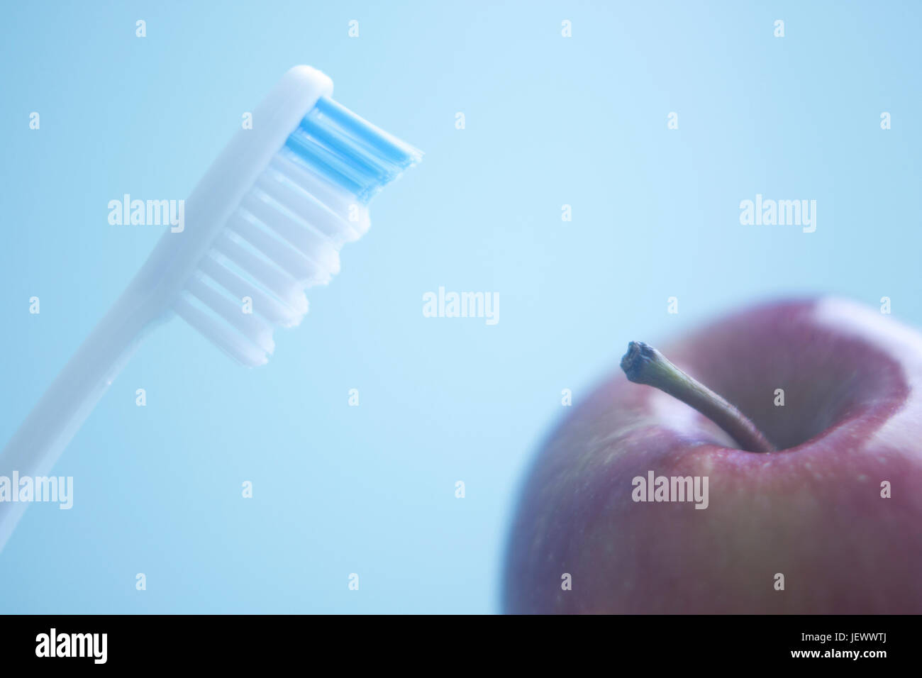 Dental toothbrush to clean teeth and fresh red apple for healthy eating ...