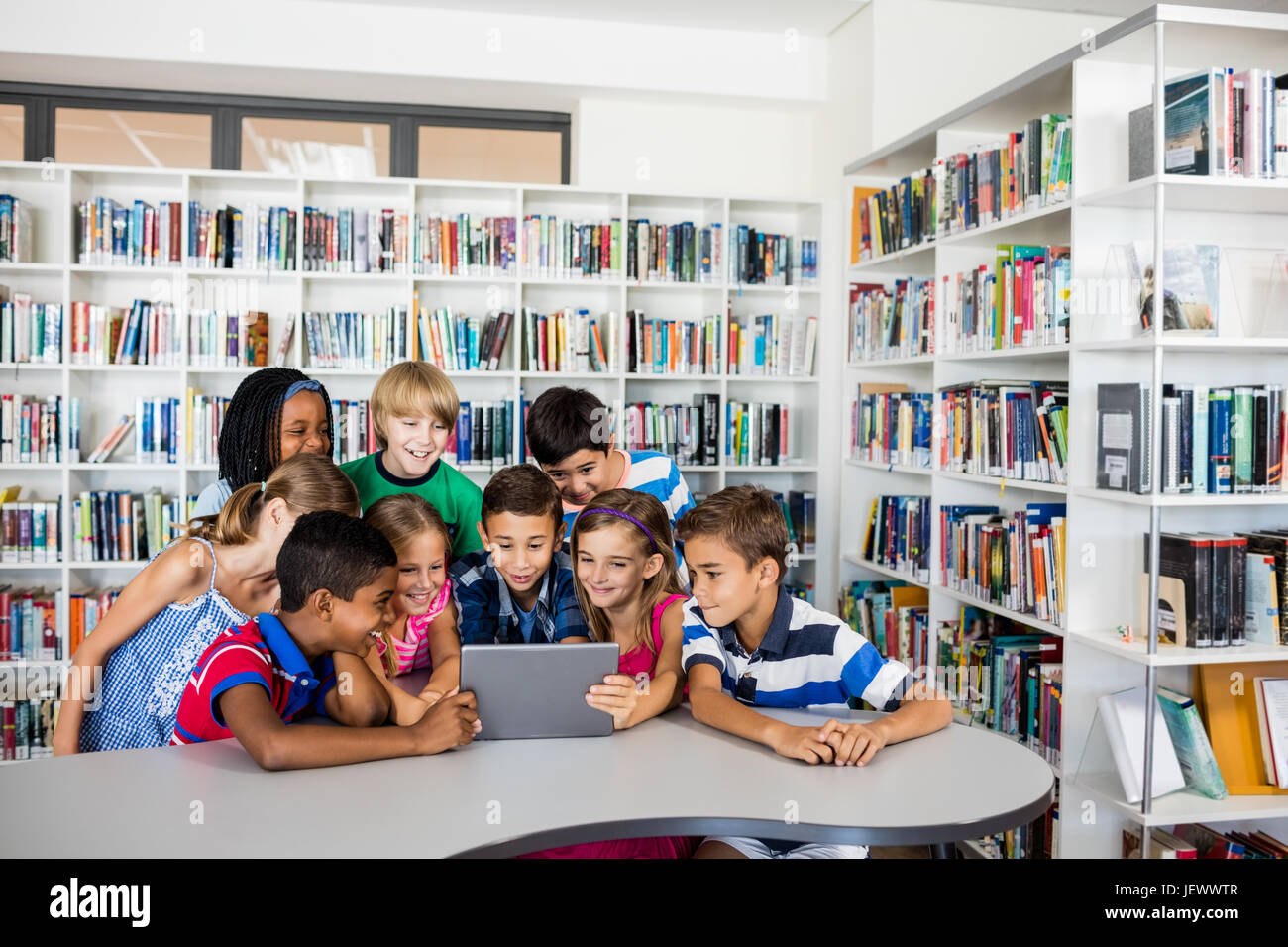 Front view of pupils using tablet pc Stock Photo - Alamy