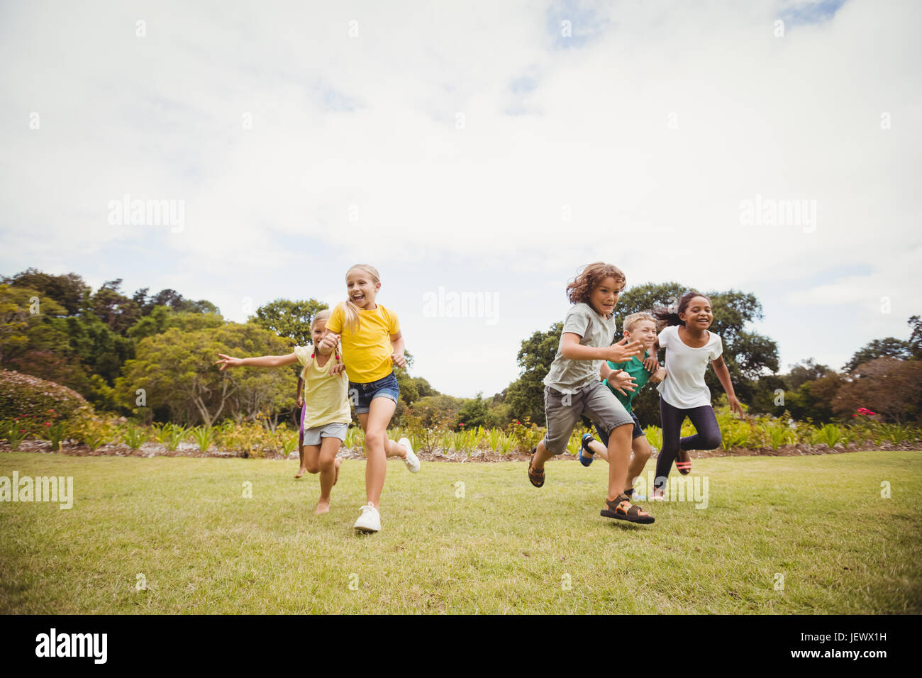 Children running hi-res stock photography and images - Alamy