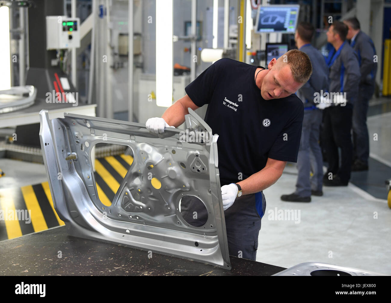 Volkswagen cars are assembled on a production line in the German car ...