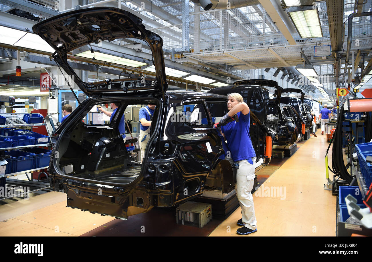 Volkswagen cars are assembled on a production line in the German car ...