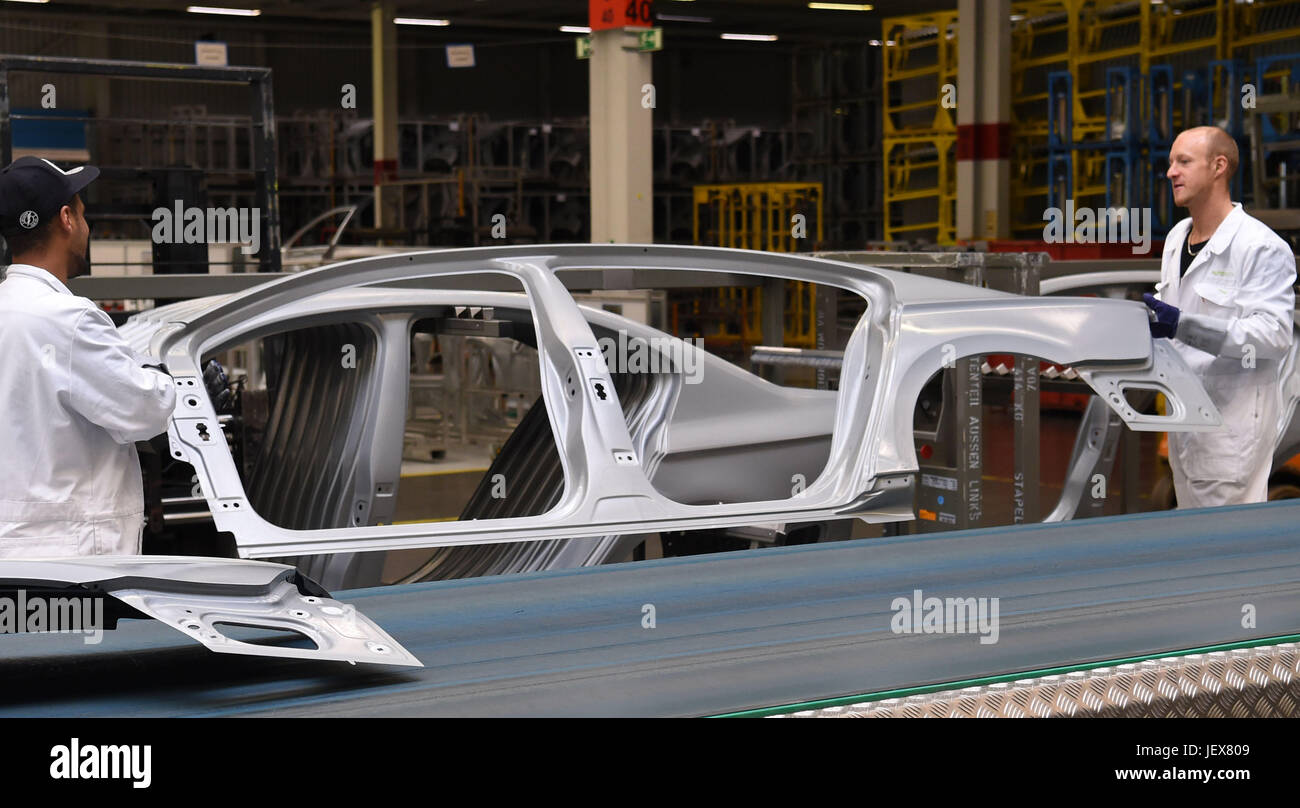 Volkswagen cars are assembled on a production line in the German car ...