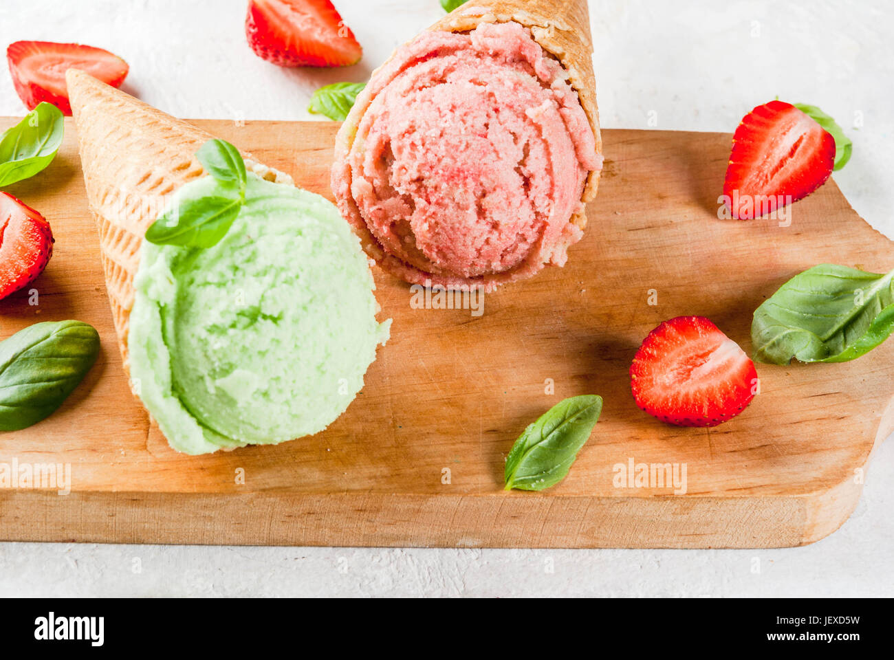 Summer fresh desserts. Green basil and red strawberry ice cream in a ...