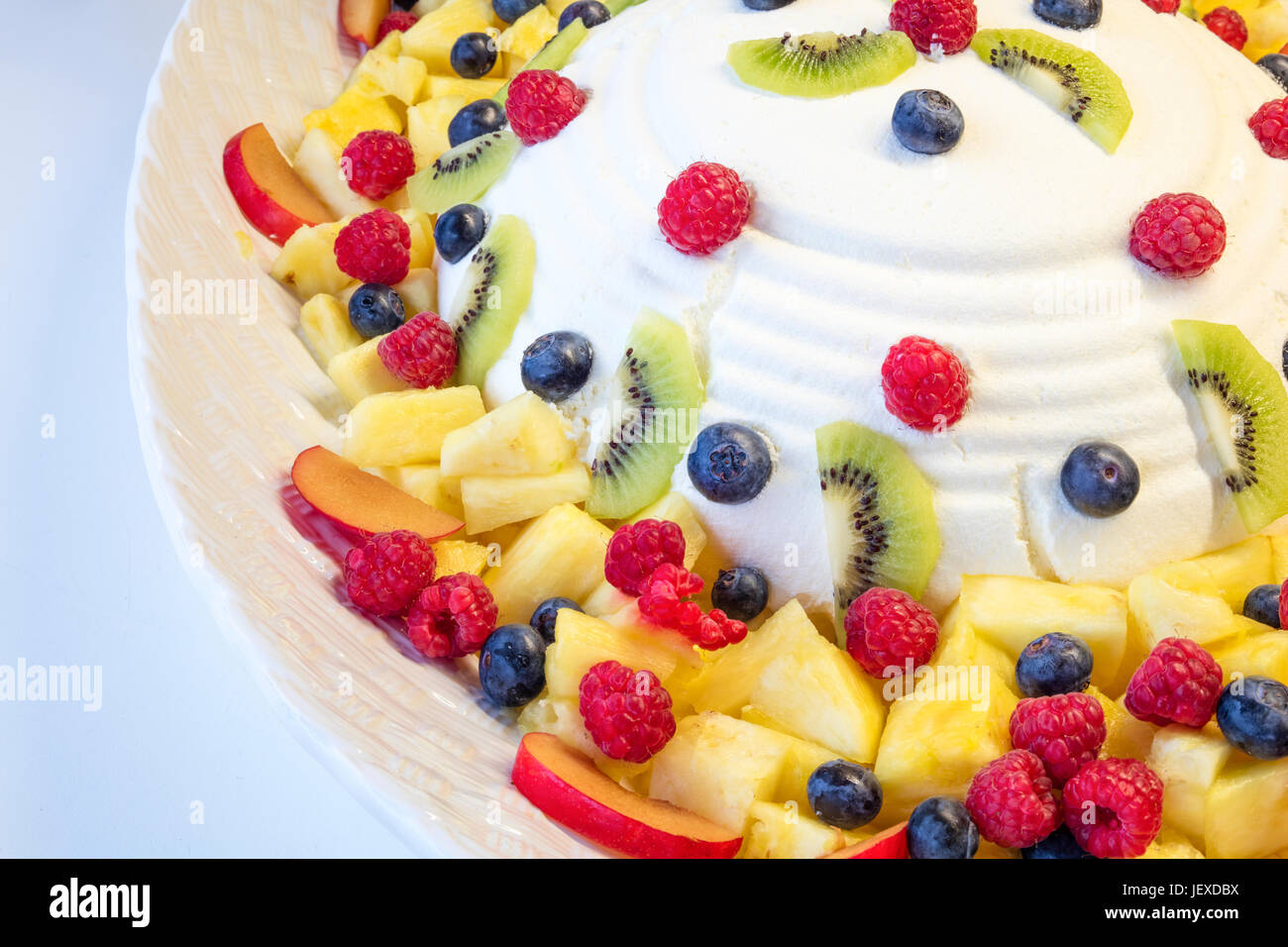 Cheese mousse with several piece of fruits such as berries, cranberries ...