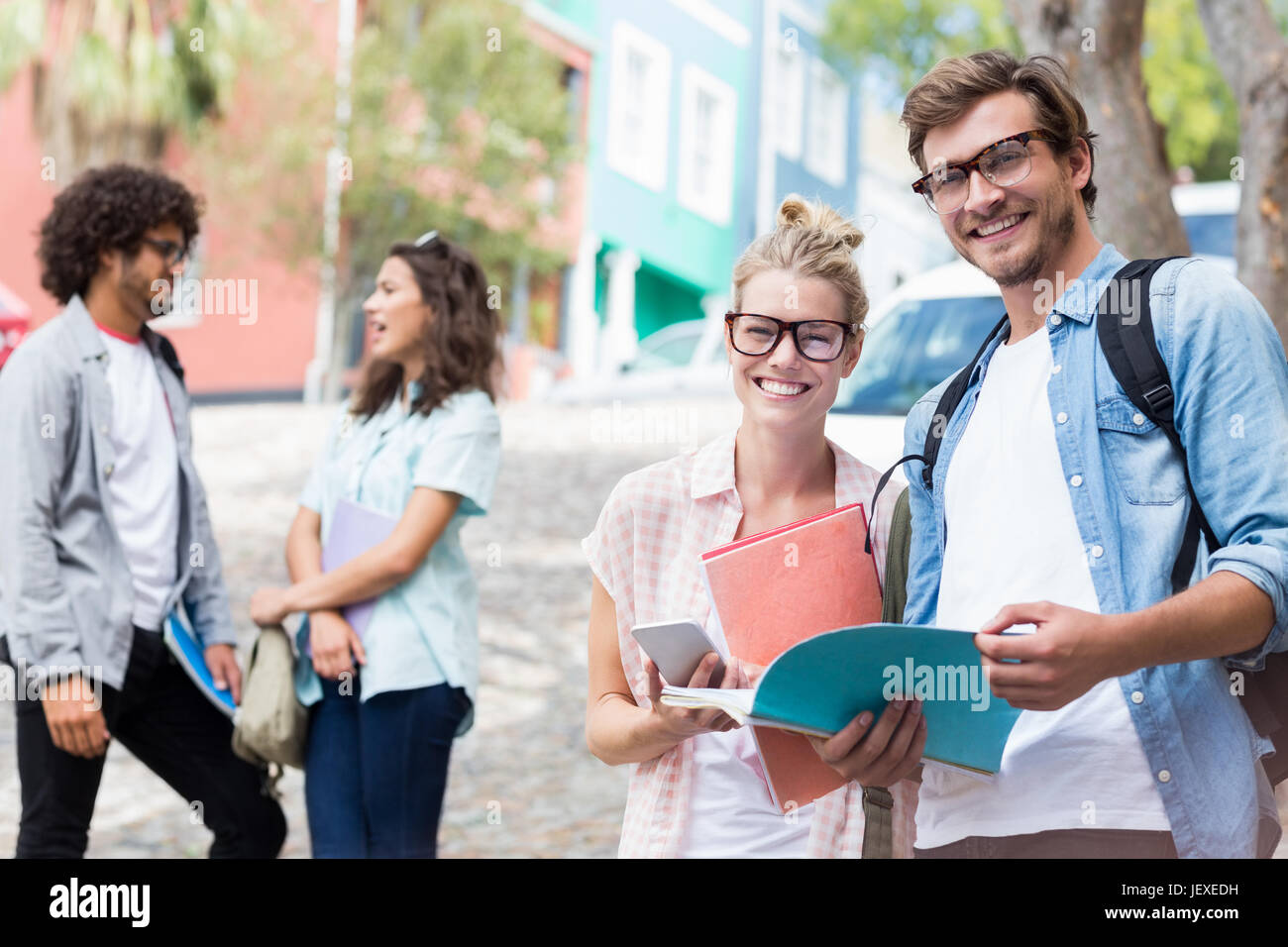 Portrait of students holding book Stock Photo - Alamy