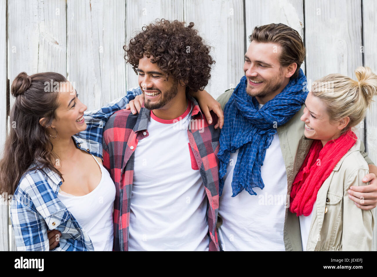 Friends standing with arms around Stock Photo - Alamy