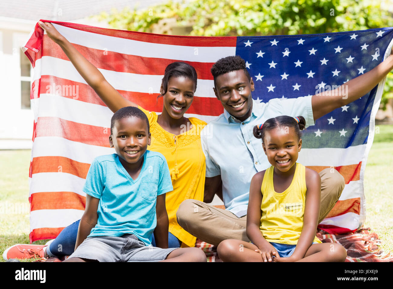Happy family showing usa flag Stock Photo - Alamy