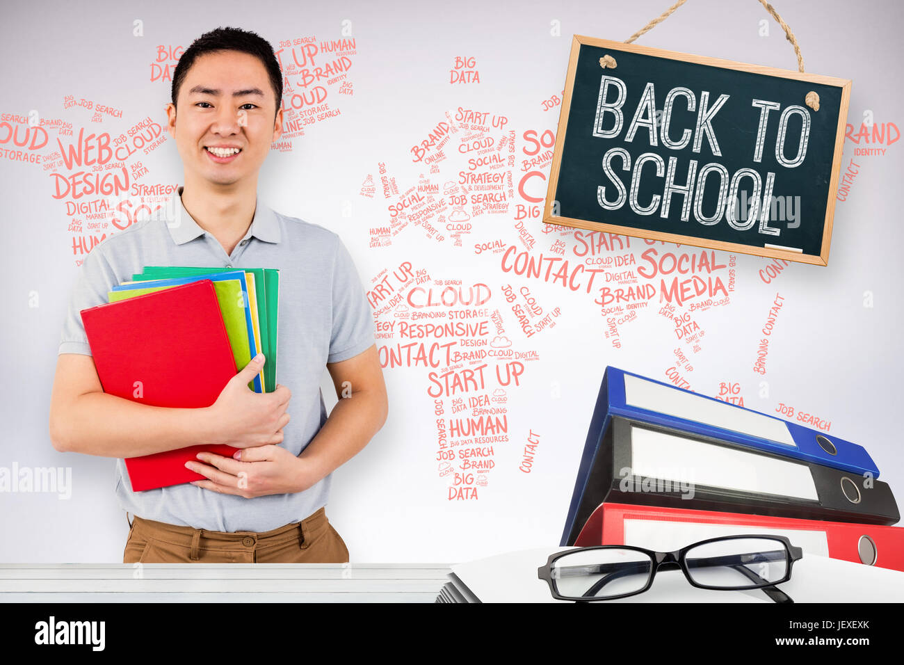 Composite image of smiling man holding files Stock Photo - Alamy