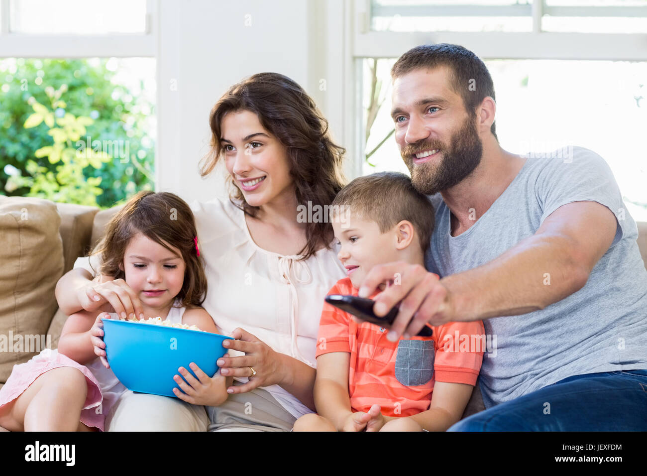 Family having fun while watching television Stock Photo - Alamy