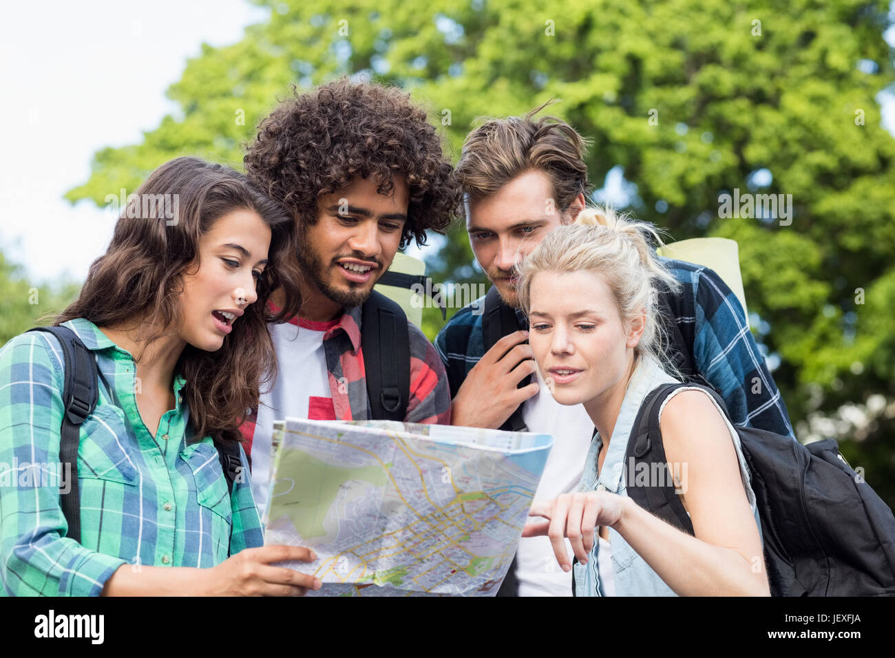 Friends looking at map Stock Photo - Alamy