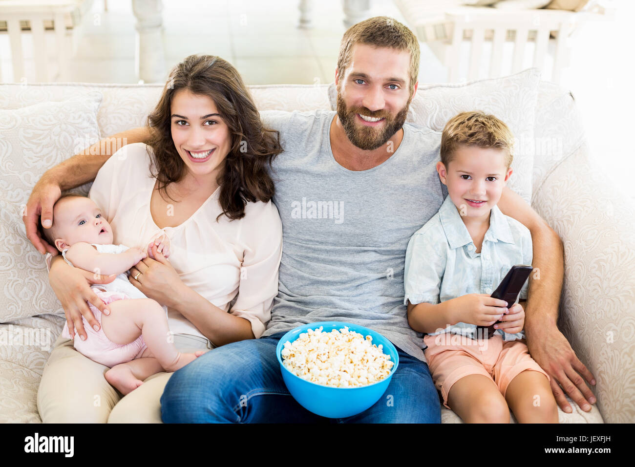 Family having fun while watching television Stock Photo - Alamy