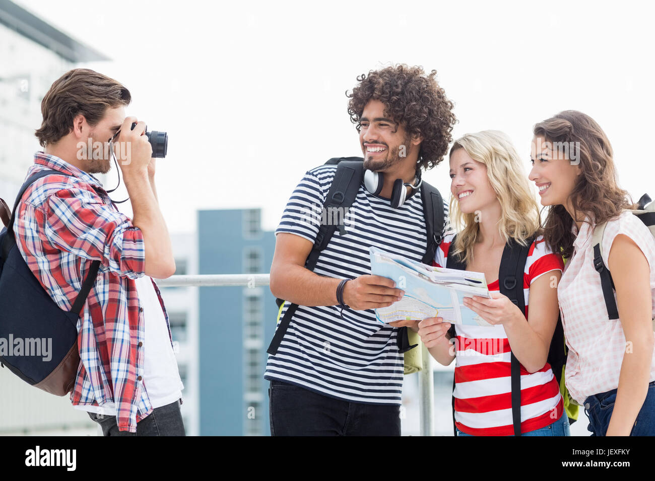 Man taking photo of his friends Stock Photo - Alamy