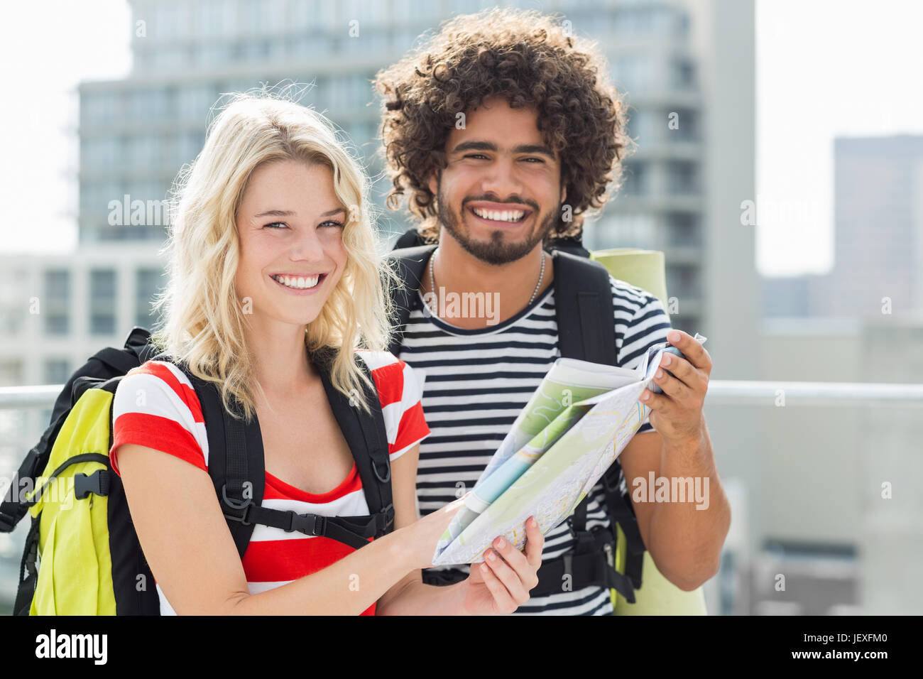Young couple holding map Stock Photo - Alamy