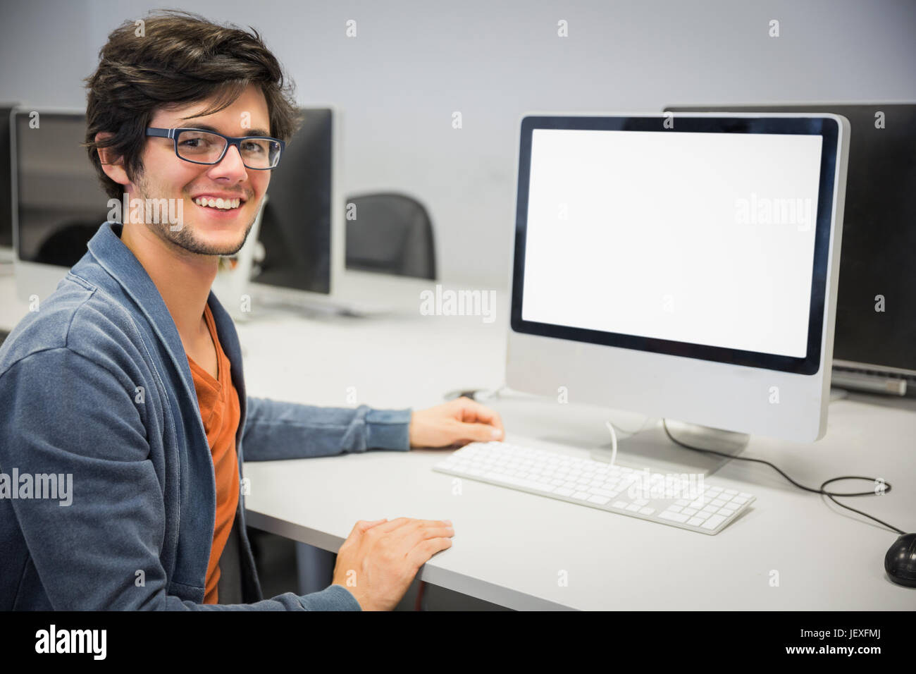 Portrait of happy student using computer Stock Photo - Alamy