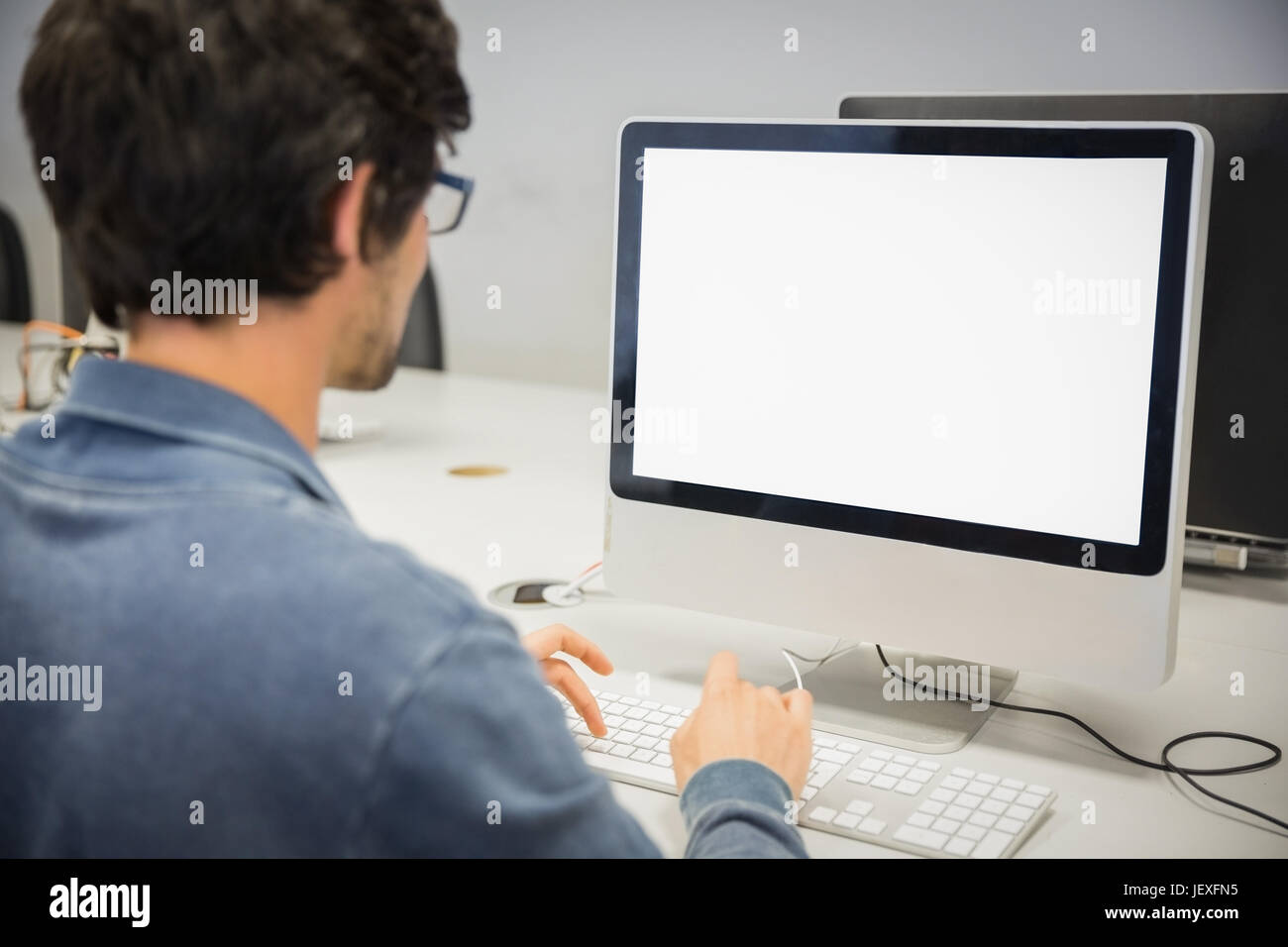Rear view of student using computer Stock Photo - Alamy