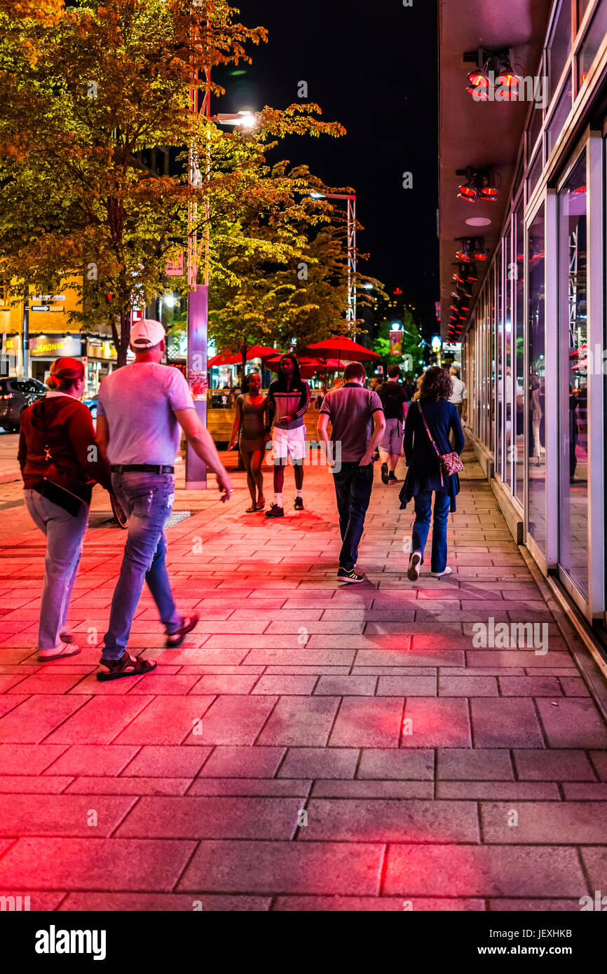 People Walking On The Street At Night