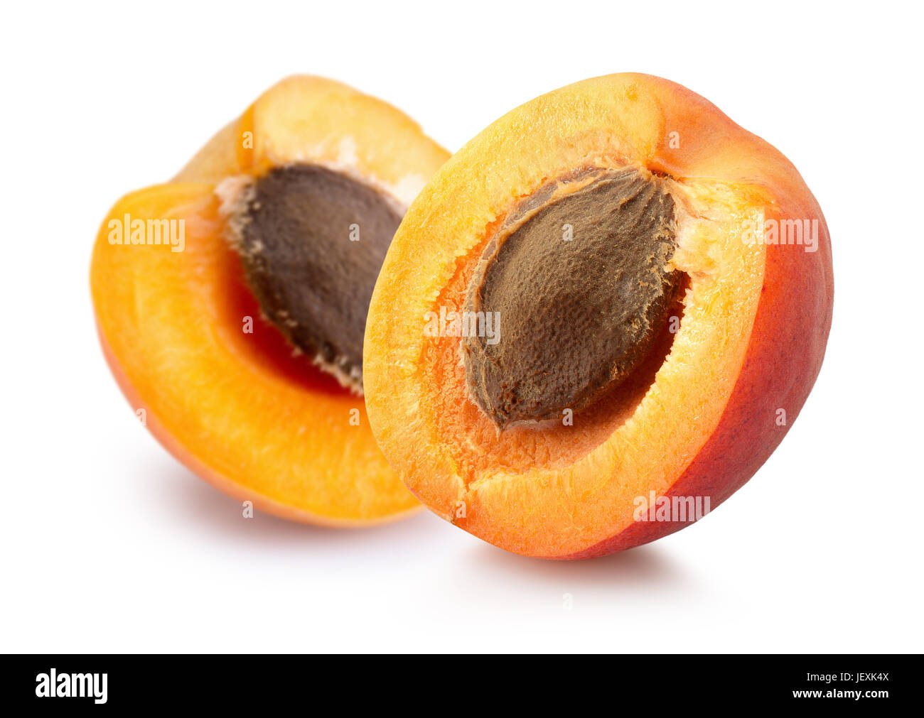 two halves of apricot isolated on a white background Stock Photo - Alamy