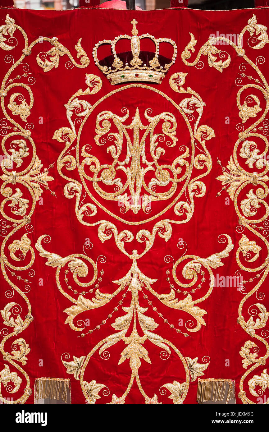 Embroidery thread of gold on red velvet, Spain Stock Photo - Alamy