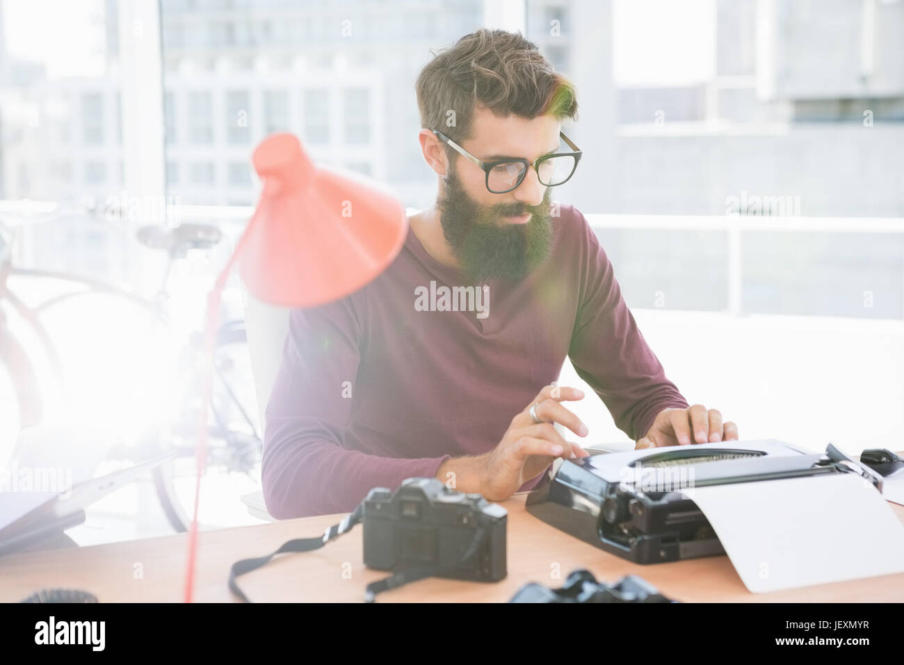 Hipster man using a typewriter Stock Photo - Alamy